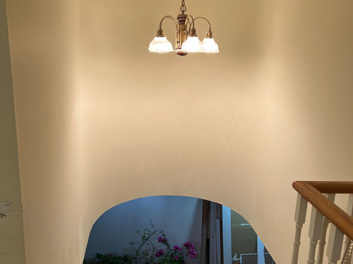 Lighting in high ceiling above stairs