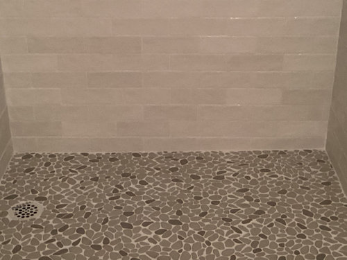 How to fix tile that is slanted with pitch of tile floor