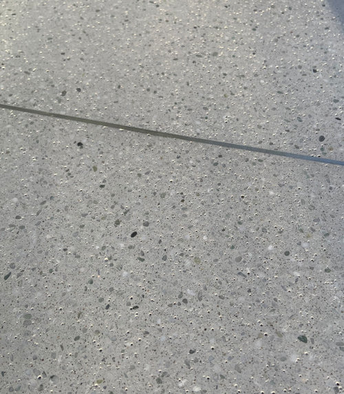 Numerous pinholes in new exposed aggregate concrete floor