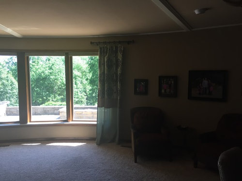 Curved wall of windows in dining/living room combo
