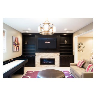 Basement Family Room with Stone Fireplace, Built-In Bookshelves, and a ...