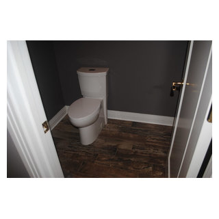 Dual flush toilet with concealed trapway, gray paint, distressed wood ...