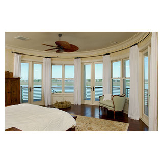 Curved window wall creates panorama of the River - Tropical - Bedroom ...