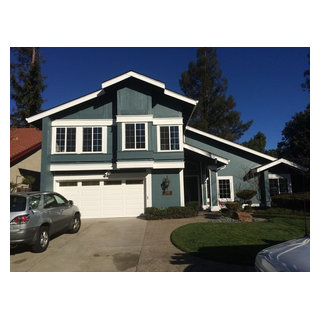 Olive green with white window trim, a white garage door and white ...