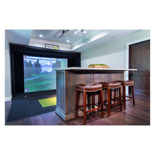 Golf simulator and bar area in basement of mountain home ...