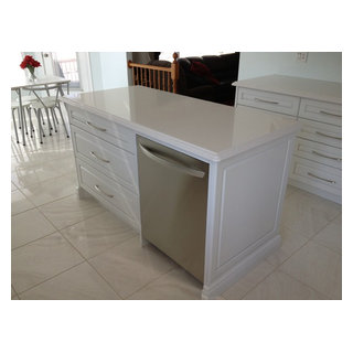 A contemporary white on white raised panel kitchen with a Cambria ...