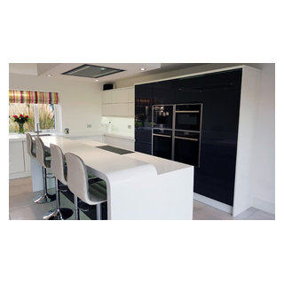 A Metz gloss white and gloss graphite kitchen with Corian worktops ...