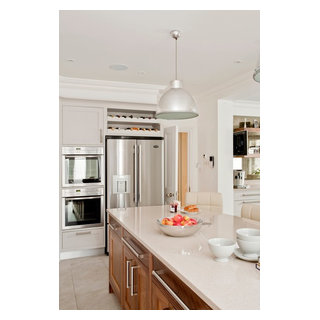 Central walnut island with built in large fridge freezer and ovens ...