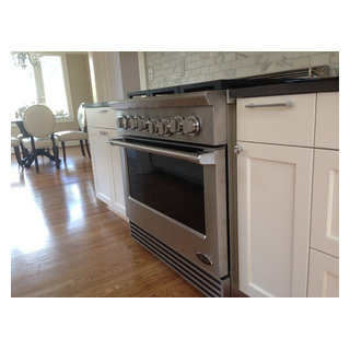 Custom cabinets, marble subway tile backsplash and 6-burner gas range ...