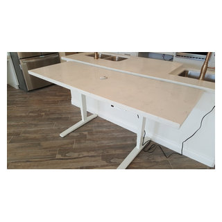 Electric, adjustable height table provides easy access for baking and ...