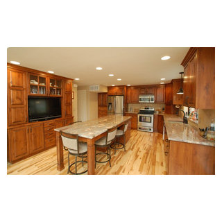 Large island with furniture-style legs and entertainment wall in ...