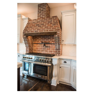 Range with brick and reclaimed beam hood - Country - Kitchen - Kansas ...
