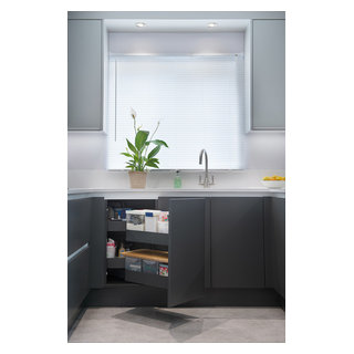 True handless monochrome panel door kitchen with Corian worktop ...