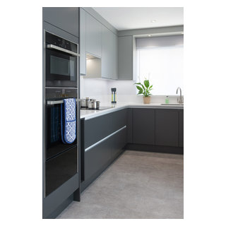 True handless monochrome panel door kitchen with Corian worktop ...