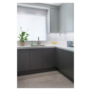 True handless monochrome panel door kitchen with Corian worktop ...