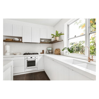 Coastal Kitchen with V-groove Cabinets and White Benchtops - Beach ...