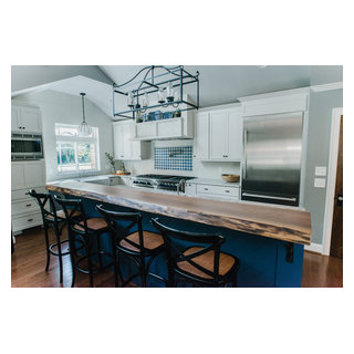 White kitchen addition with large live edge bar and island ...
