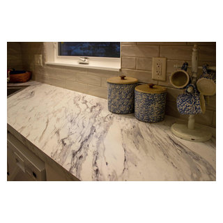 White Kitchen with Calcutta Marble Laminate Countertop and Tile ...