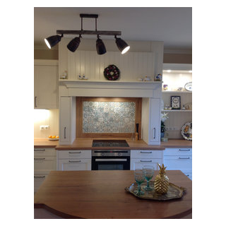 schicke Landhausküche mit Arbeitsinsel und stylischem Fliesenspiegel ...