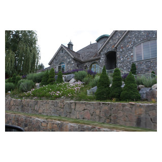 Home with Cobblestone Retaining Wall Side View - Traditional - Garden ...