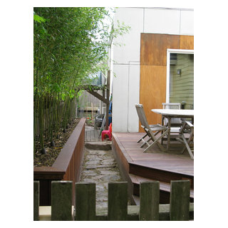 View through to storage and bamboo planter, sunken stone path, and deck ...