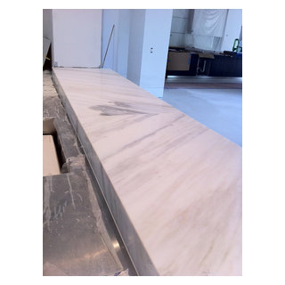 bar with suspended counter top book matched calacatta marble ...