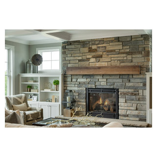 Rustic Stone Fireplace Illuminates This Traditional Living Room ...