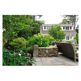 Bluestone patio with New England fieldstone seat wall and plantings ...