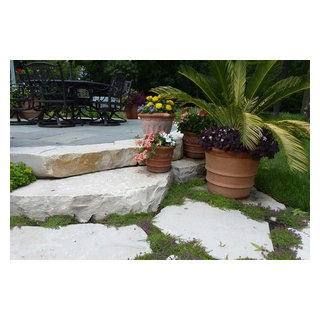Closeup of outcropping stone steps to elevated bluestone patio ...