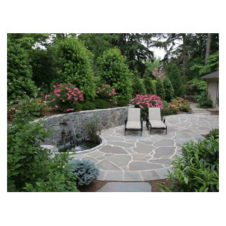 Flagstone Patio with Sheer Descent Water Feature and Rose Bushes ...