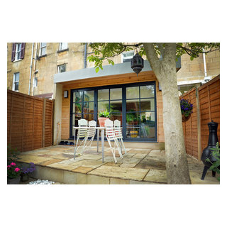 Overhanging roof with timber soffits and ashlar stone side walls ...
