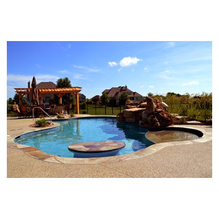 Free form pool with stone table, sun shelf, water feature, and outdoor ...