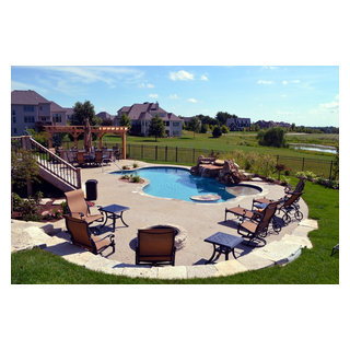 Free form pool with stone table, sun shelf, water feature, and outdoor ...