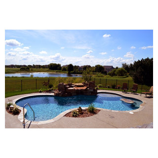 Free form pool with stone table, sun shelf, water feature, and outdoor ...