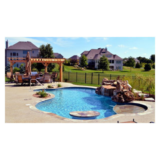 Free form pool with stone table, sun shelf, water feature, and outdoor ...