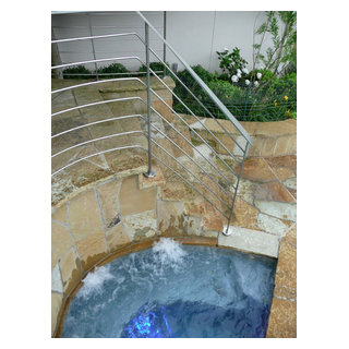 Hot Tub Nestled Between Staircase Built from Flagstone and Stainless ...
