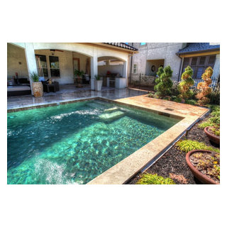 Rectangular pool with walkover water feature, fire pit, and landscape ...