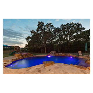 Rustic lagoon style pool with a fire pit, water falls and a hot tub ...
