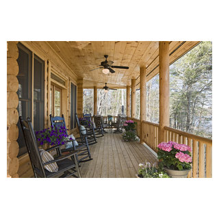Exterior of a rustic round log and timber home - Traditional - Porch ...