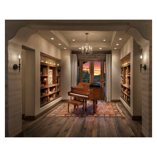 The Music Room/Library is seen through corbeled arched opening, with ...