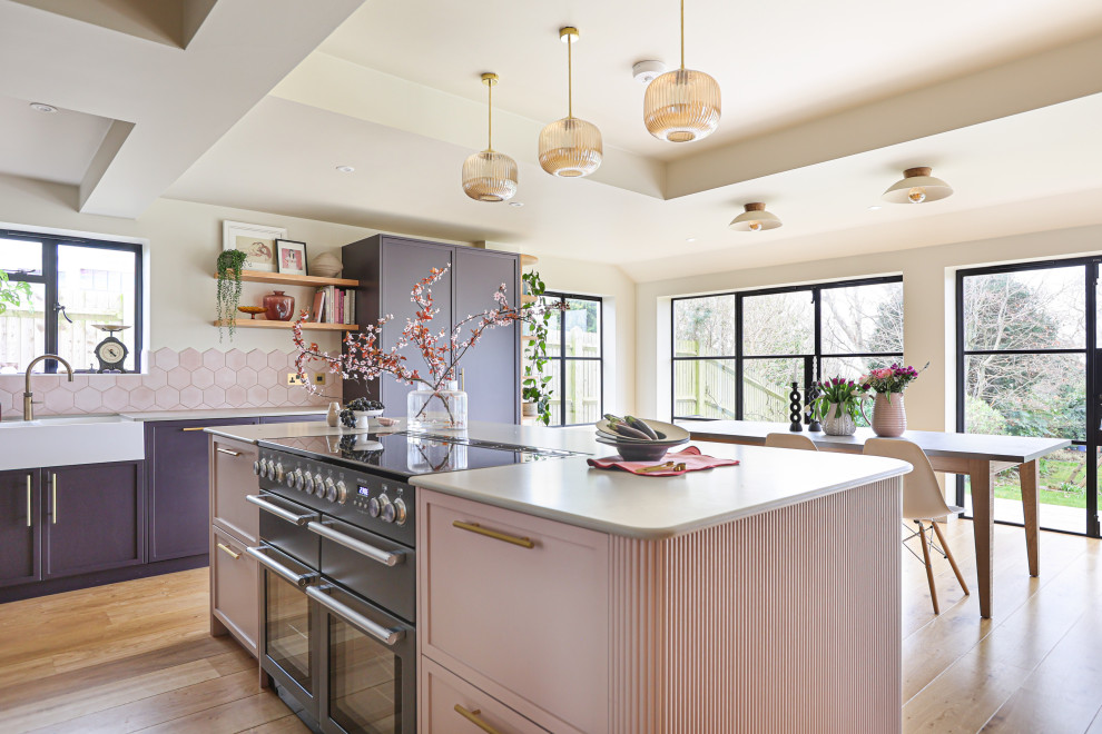 Pink kitchen island with fluted panelling and range oven - Contemporary - Kitchen - Sussex - by ...