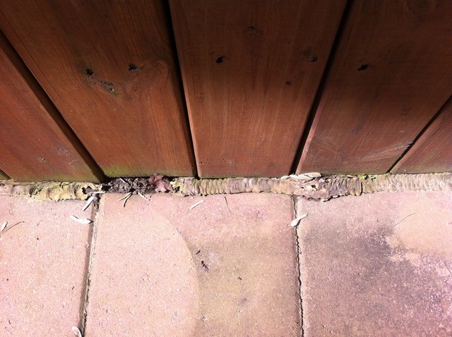 Create a mud barrier at bottom of fence and patio?