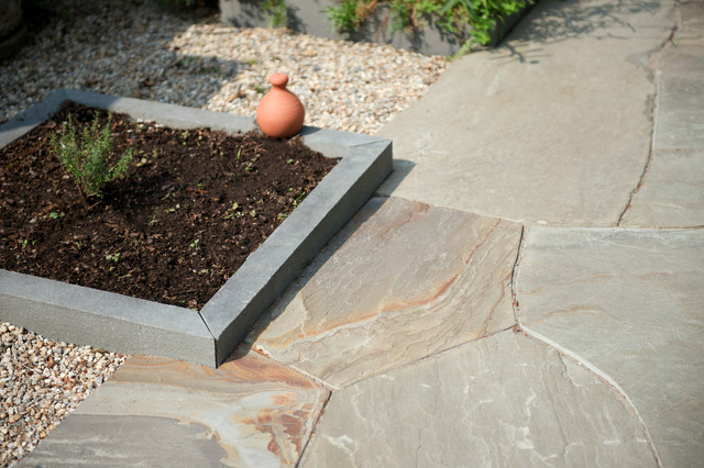 Natural cleft bluestone walkway, cut around raised bluestone herb beds ...