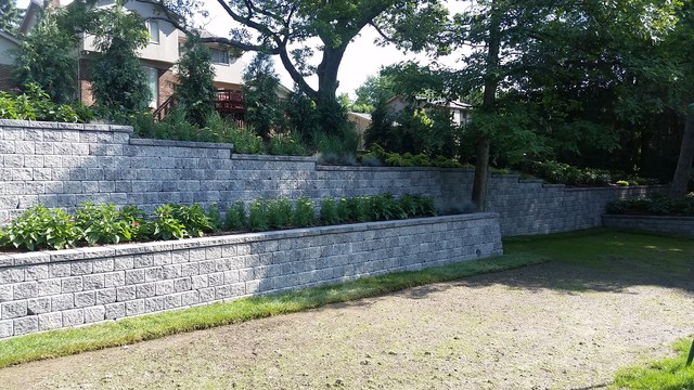 Tiered Unilock Roman Pisa Retaining Walls - Traditional - Garden ...