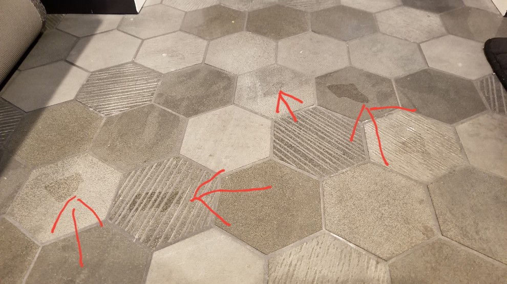 natural stone tiles in bathroom have dark spots on it!