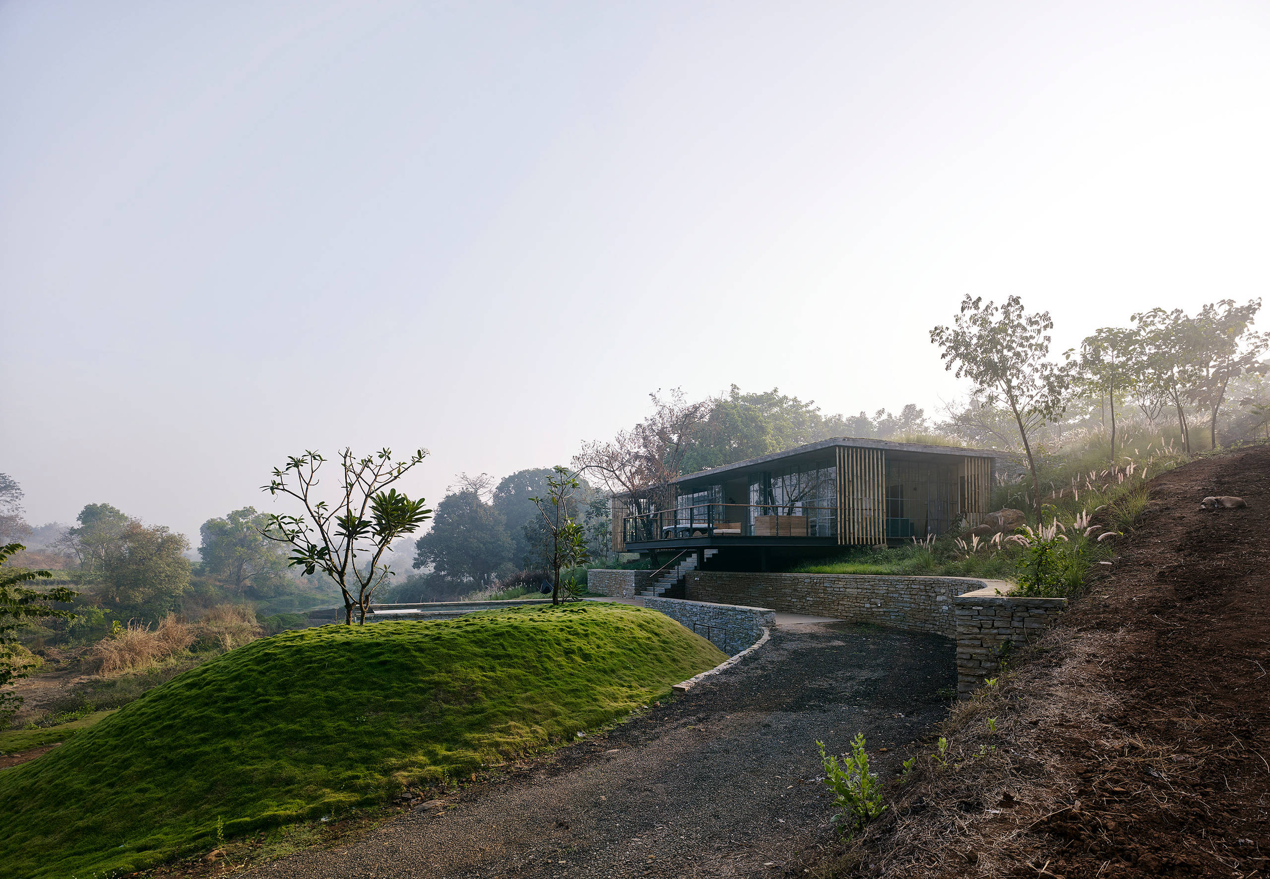 A Riverfront Home in the Ghats is Camouflaged With a Green Roof