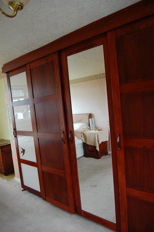 Stained Oak wardrobes with mirrored and panelled doors - Traditional ...