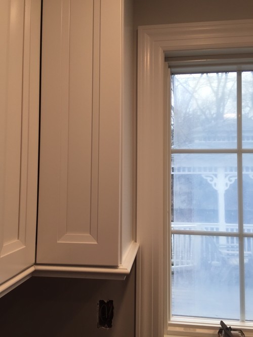 Light rail molding is overlapping window trim on one side.