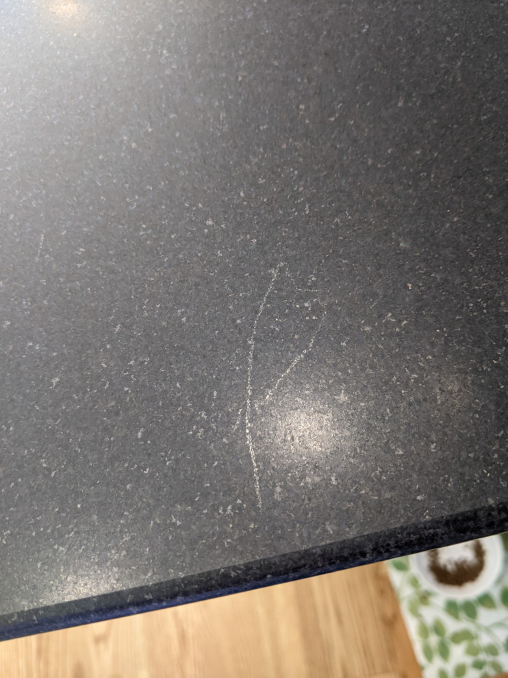 Help please: Metal? marks on honed absolute black granite?
