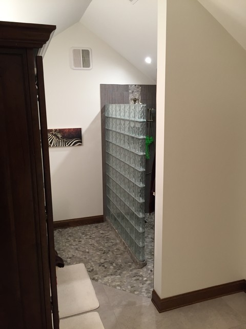 One level open shower with a prefabricated glass block shower wall ...